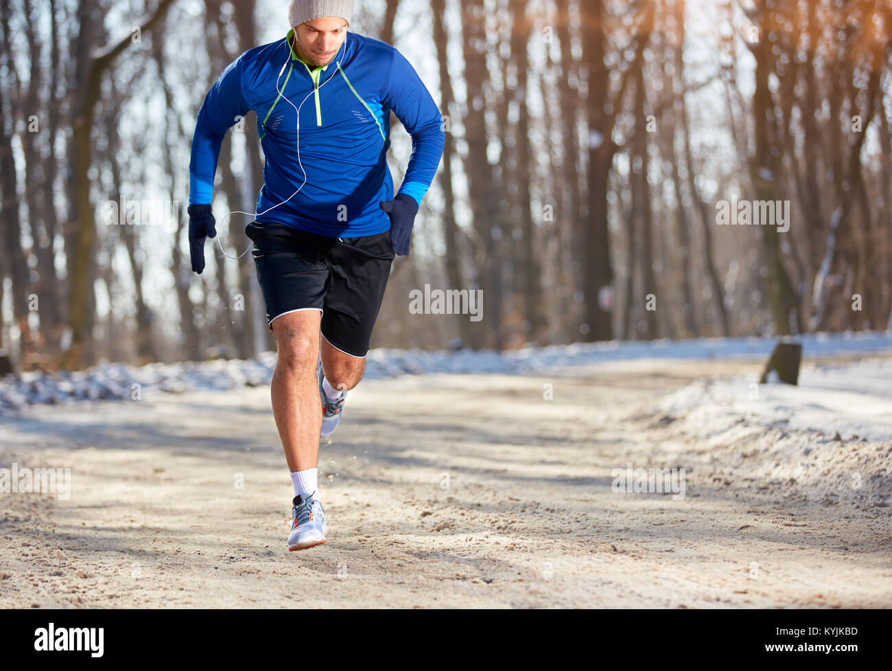 Male sprinter running in nature in the winter Stock Photo - Alamy
