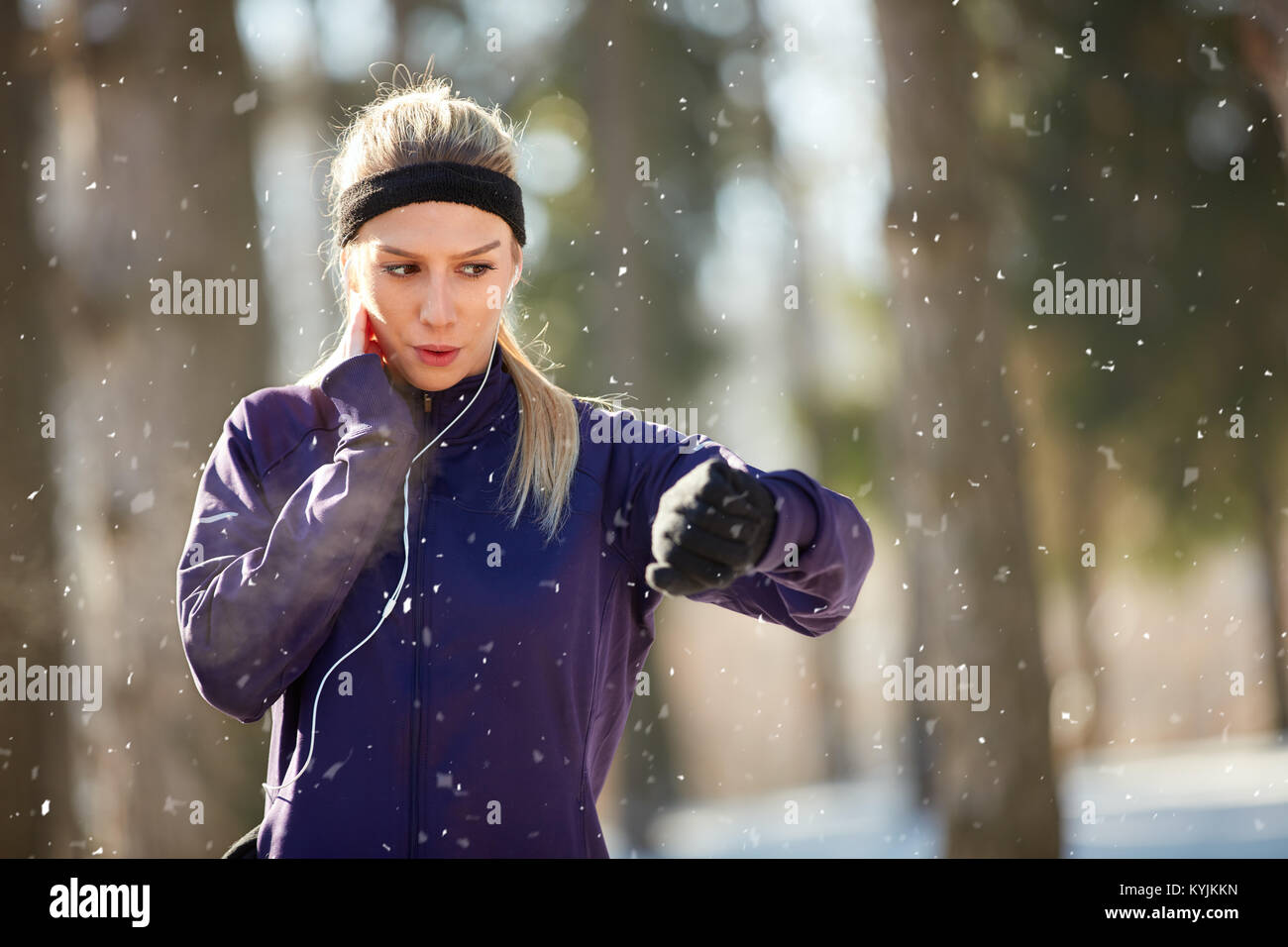 Female on pause from cardio training controls pulse outdoor Stock Photo ...