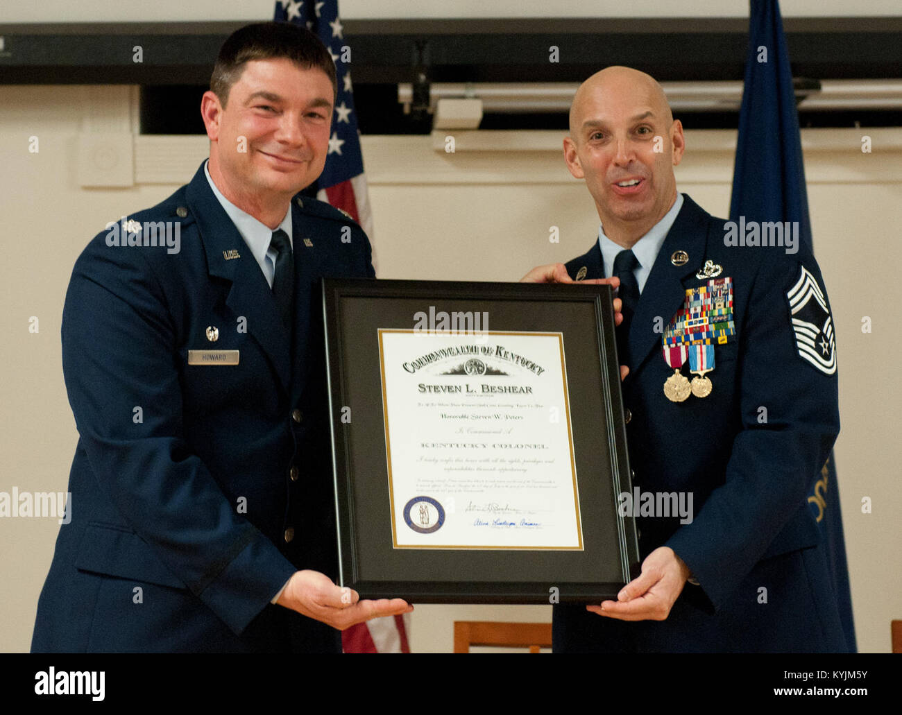 Chief Master Sgt. Steven Peters (right) is presented with a Kentucky ...