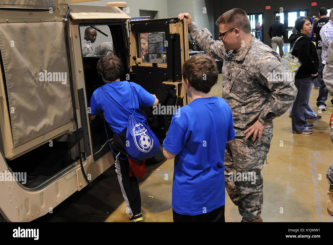 Spc. Matthew Green of the 138th Fires Brigade holds the door of a ...