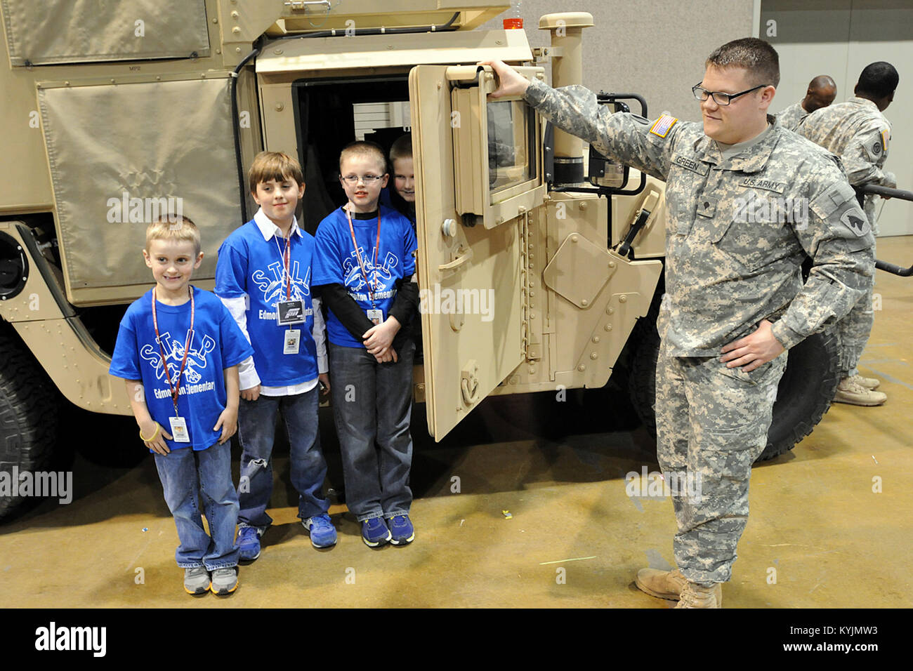 Spc. Matthew Green of the 138th Fires Brigade holds the door of a ...