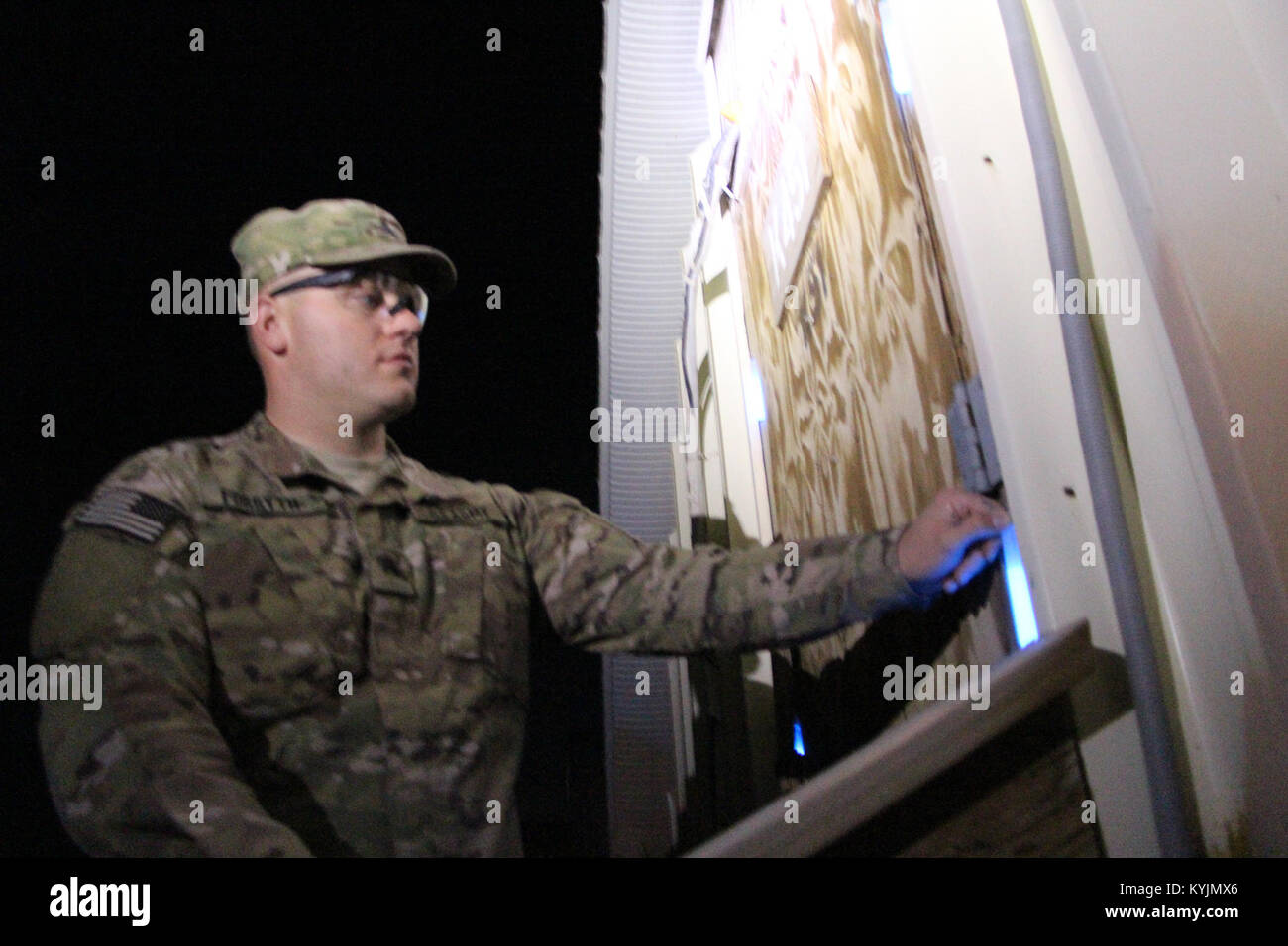 Sgt Gary Forsyth a vertical engineer with the149th hangs blue lights ...