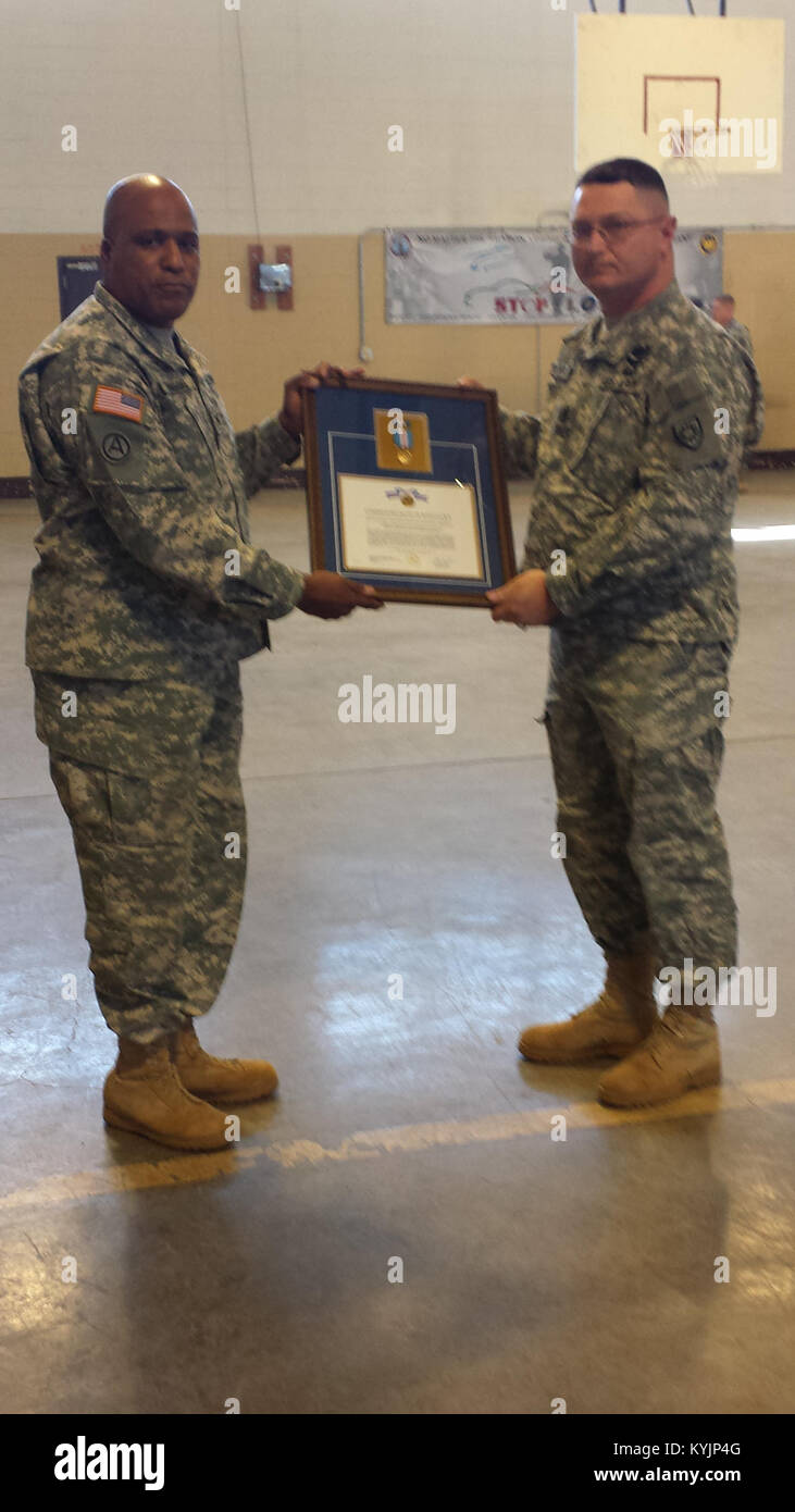 Col. John Edwards presents Command Sgt. Maj. Nathan Tolliver with the ...