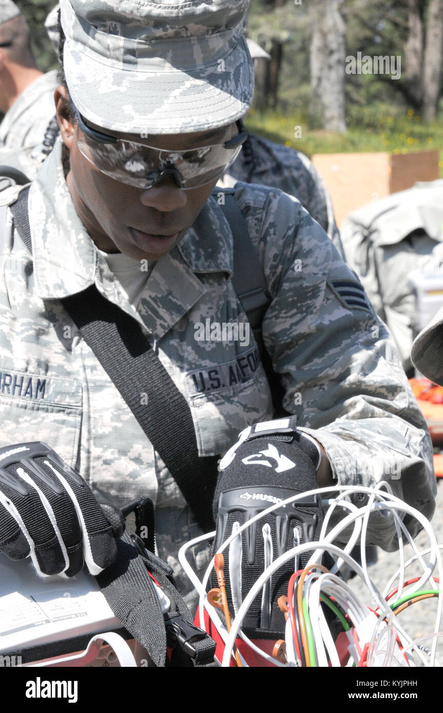 Senior Airman Buni Durham, a Kentucky Air National Guard medic, sets up ...