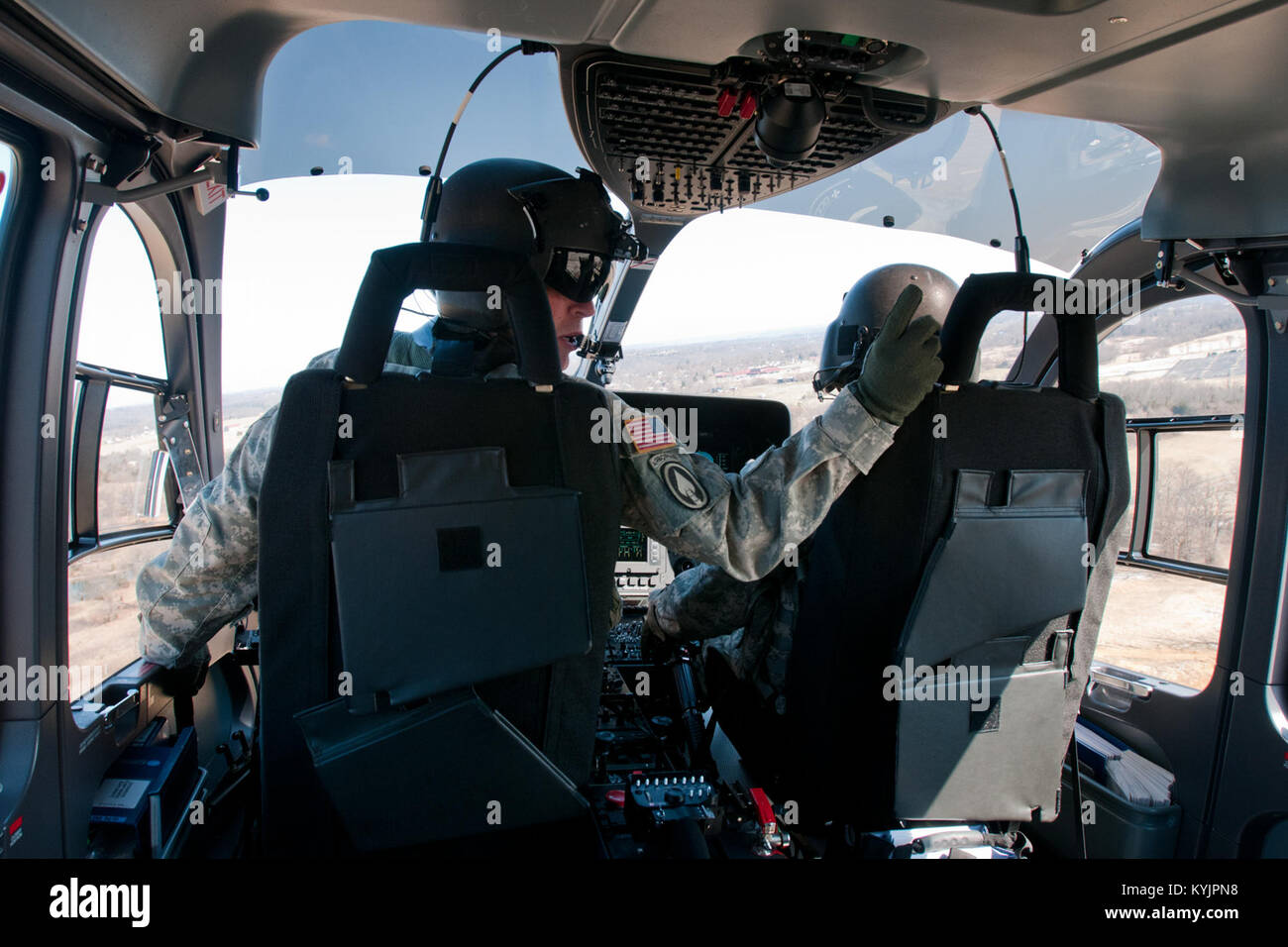 Chief Warrant Officer John Boyle looks out the side window of a LUH-72 ...