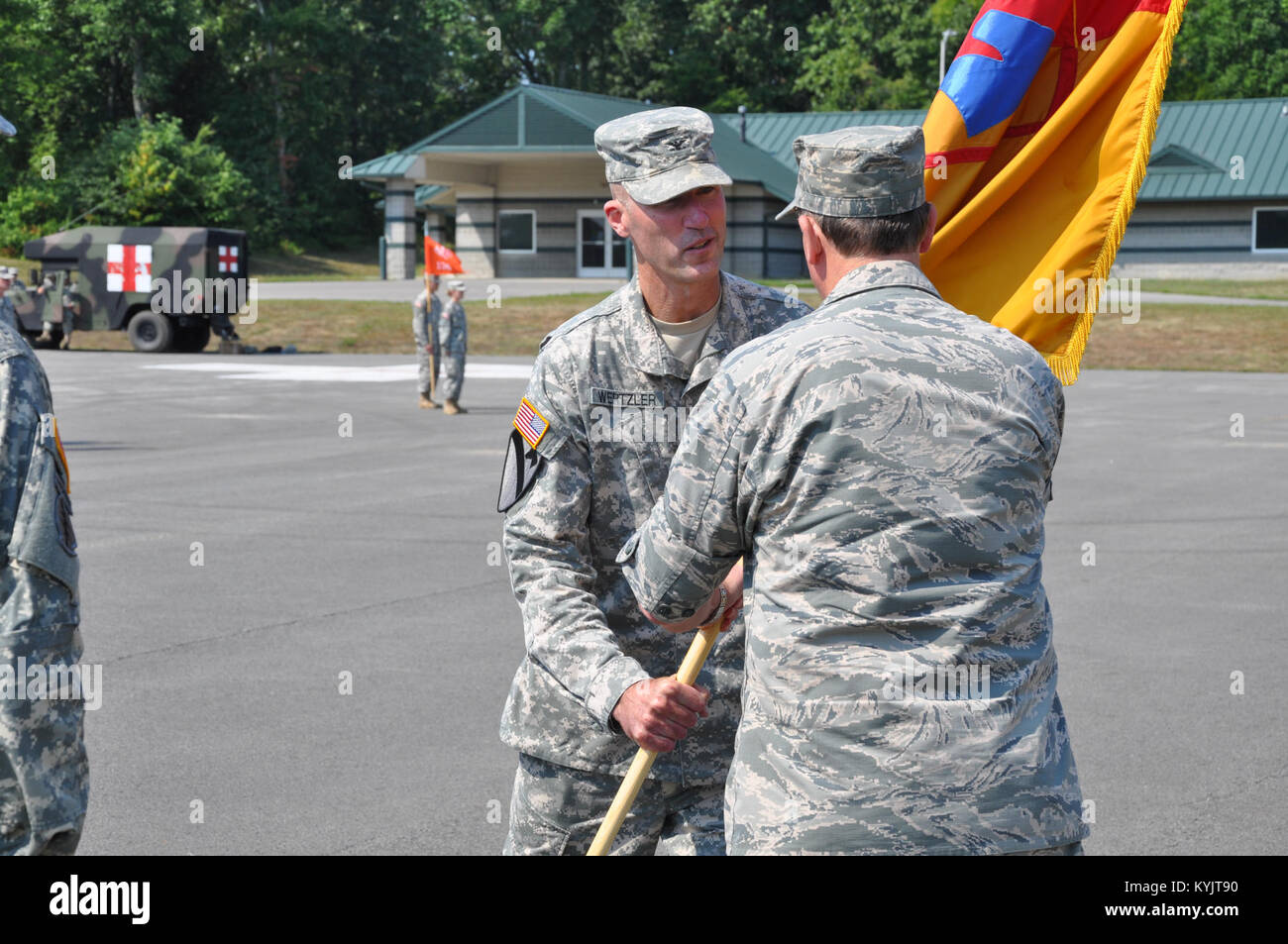 Col. Brian F. Wertzler passes the colors to Maj. Gen. Edward W. Tonini ...