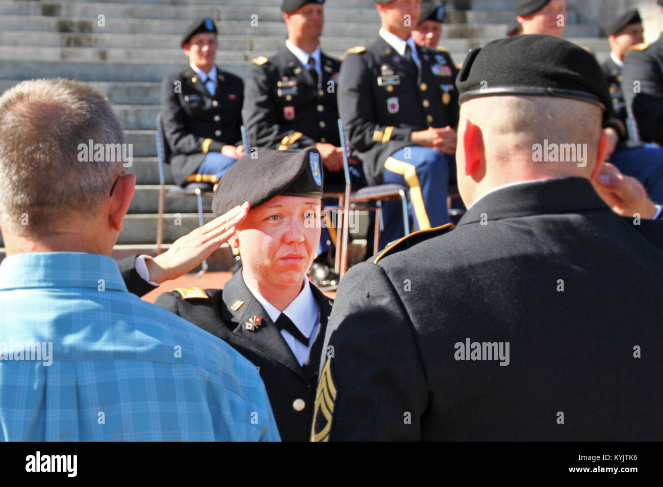 Second Lt. Cassandra Mullins salutes her husband, Master Sgt. Tim ...