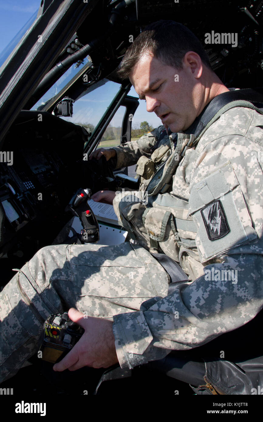 Chief Warrant Officer Travis Rogers inspects cockpit controls of a UH ...