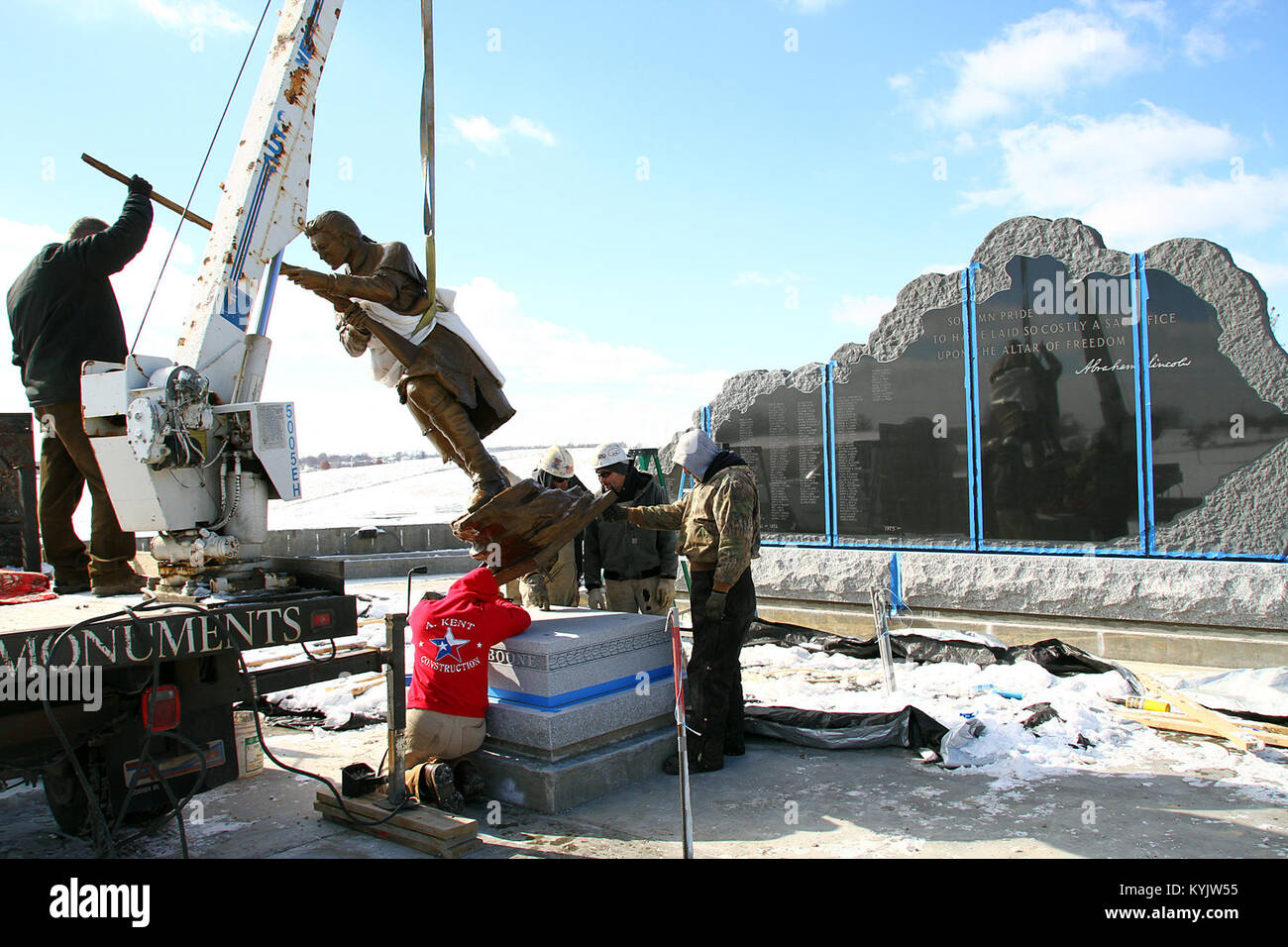 Constructions workers set a statue of Daniel Boone into place at the ...