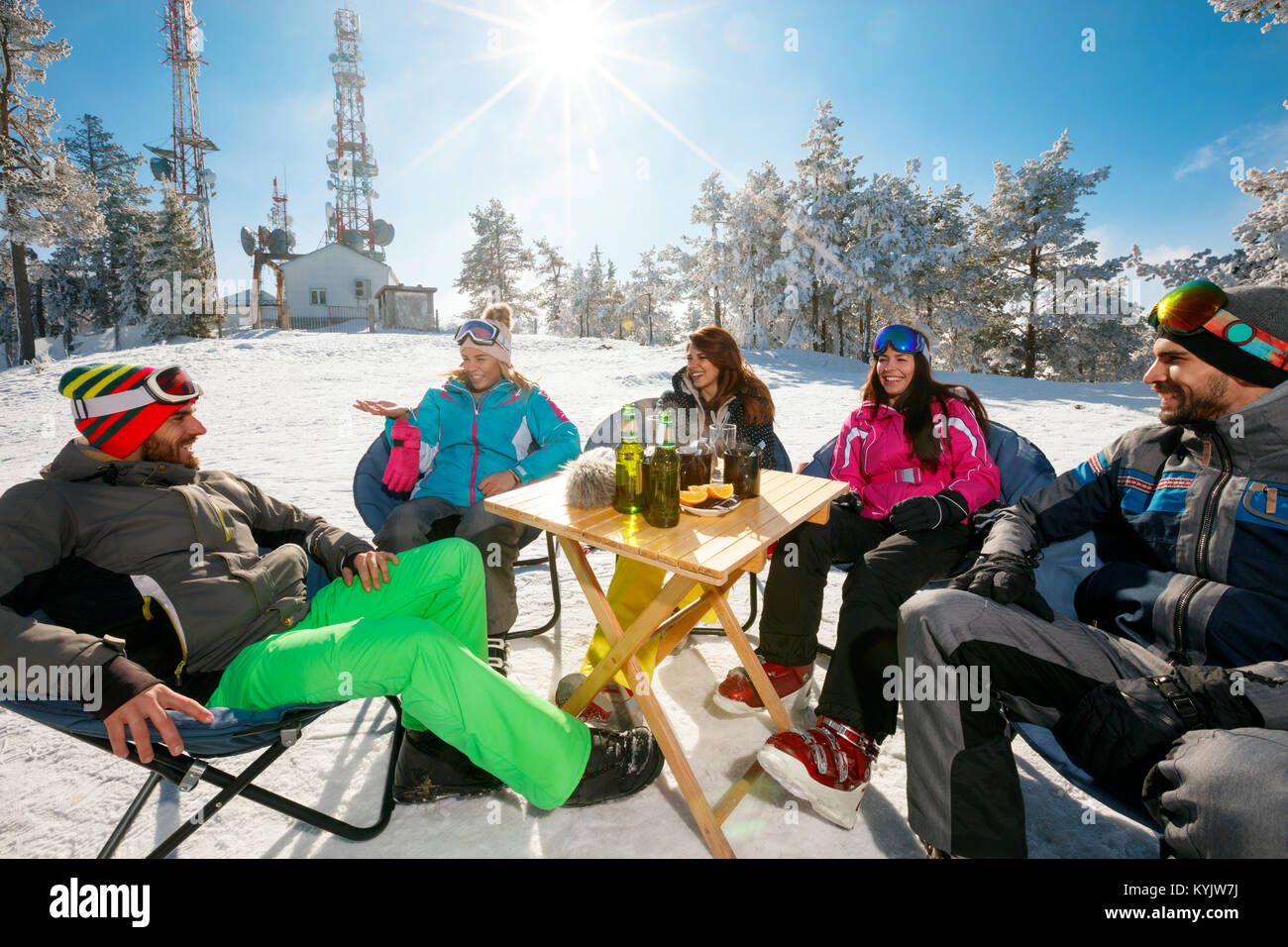 Skiing, winter fun – Smiling friends enjoying on hot drink at ski ...