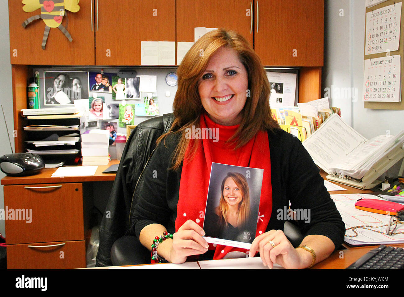 Eva Slusher holds a photo of her daughter at her office in Frankfort ...
