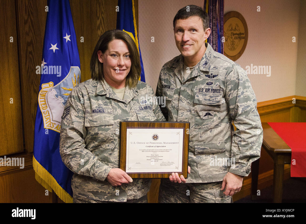 Col. Jeff Wilkinson, vice commander of the 123rd Airlift Wing, presents ...