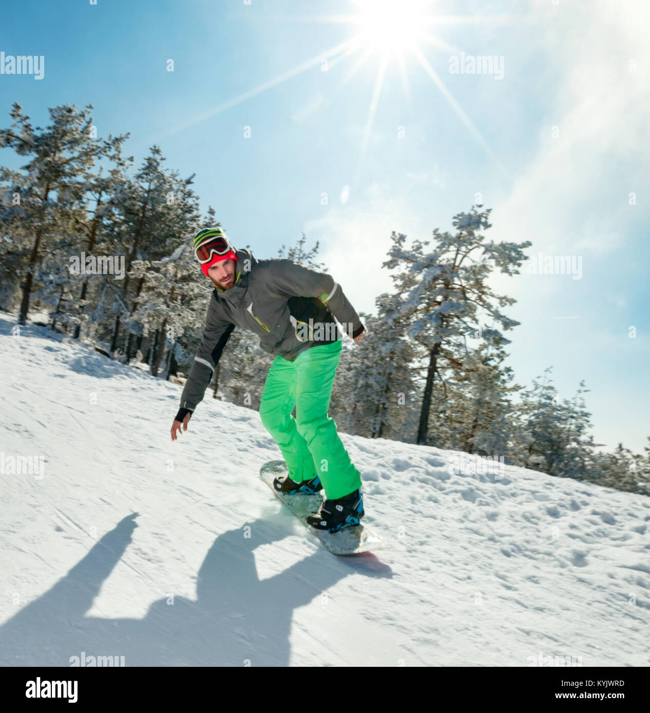 Male snowboarder enjoys the ski resort at mountain Stock Photo - Alamy
