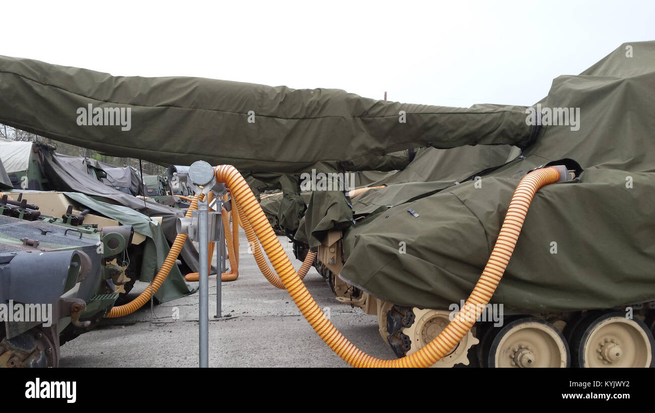 US Army National Guard tanks under protective air conditioned covers ...