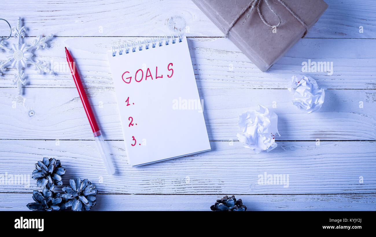 Workplace with a diary, decorations and gifts. New Year's list o Stock ...