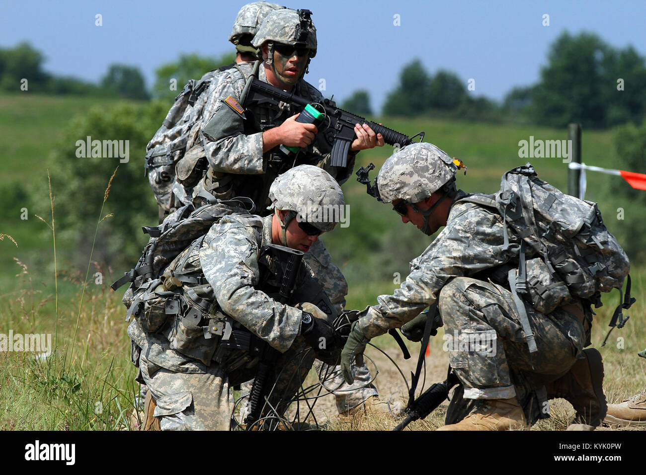 Soldiers with the 1123rd Sapper Company place detonation cord to breach ...
