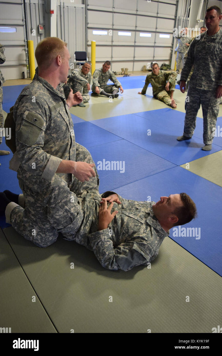 2nd Lt. Pete Knight (left) demonstrates a combatives drill with Staff ...