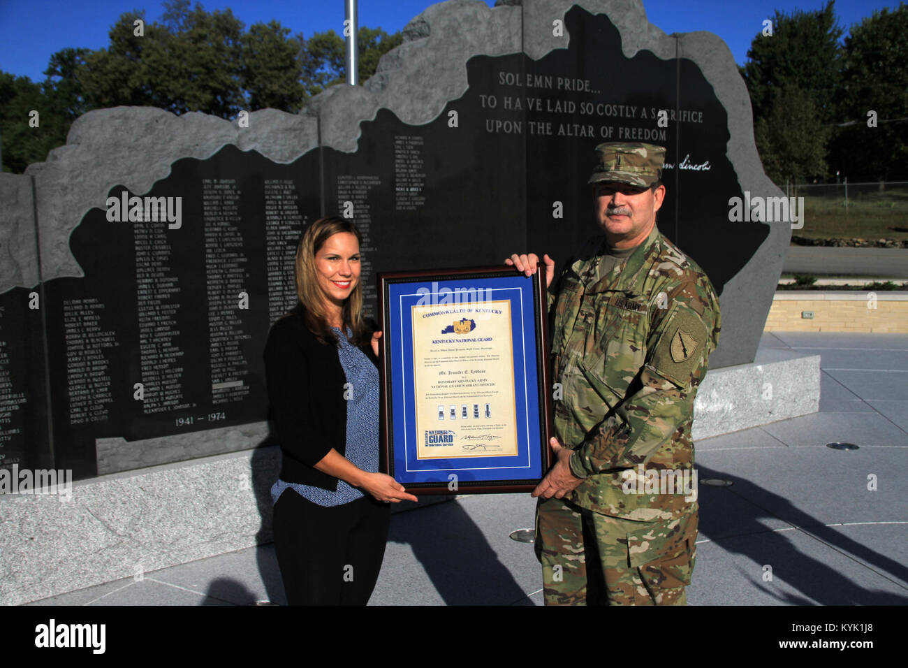 CW5 Dean Stoops presents a token of appreciation to Jennifer Lyddane ...