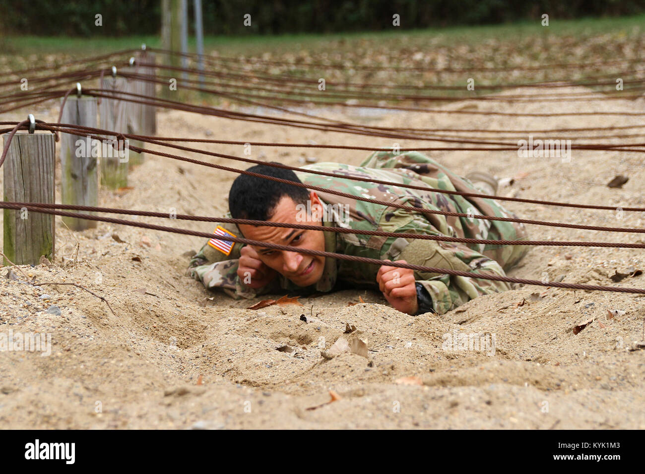 Spc. Zachary Cox low crawls through the confidence course during the ...