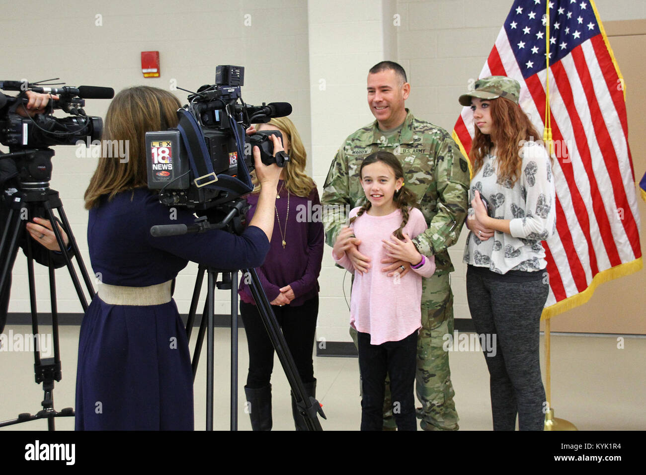 Lt. Col. Joe Warren and his family are interviewed during a departure ...