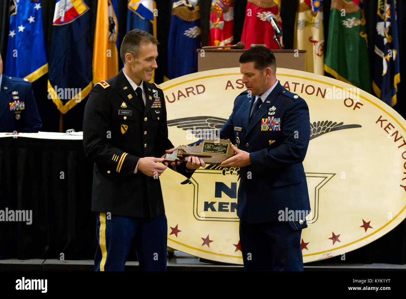 Lt. Col. Ash Groves (right) presents Maj. John Harvey with the ...