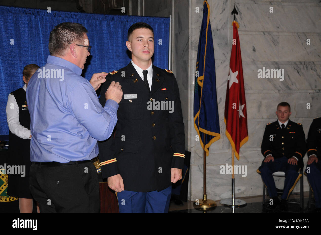 Newly promoted 2nd Lt. Ross Rigsby receives his new rank from his ...