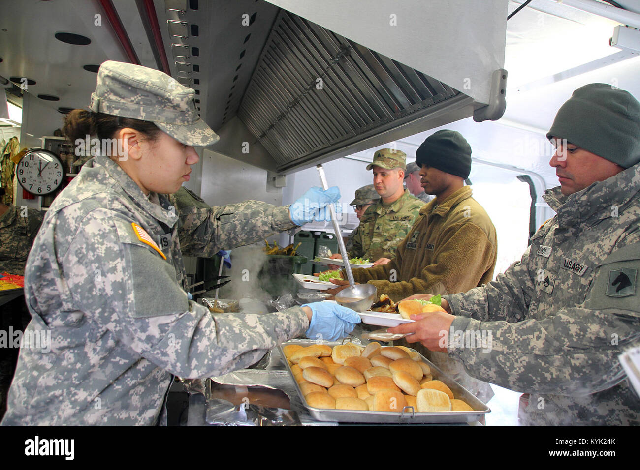 Soldiers with the 2112th Mess Team serves lunch to Soldiers during the ...