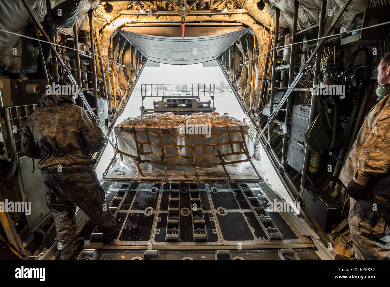 Aerial porters from the 123rd Airlift Wing load a pallet of cargo nets ...