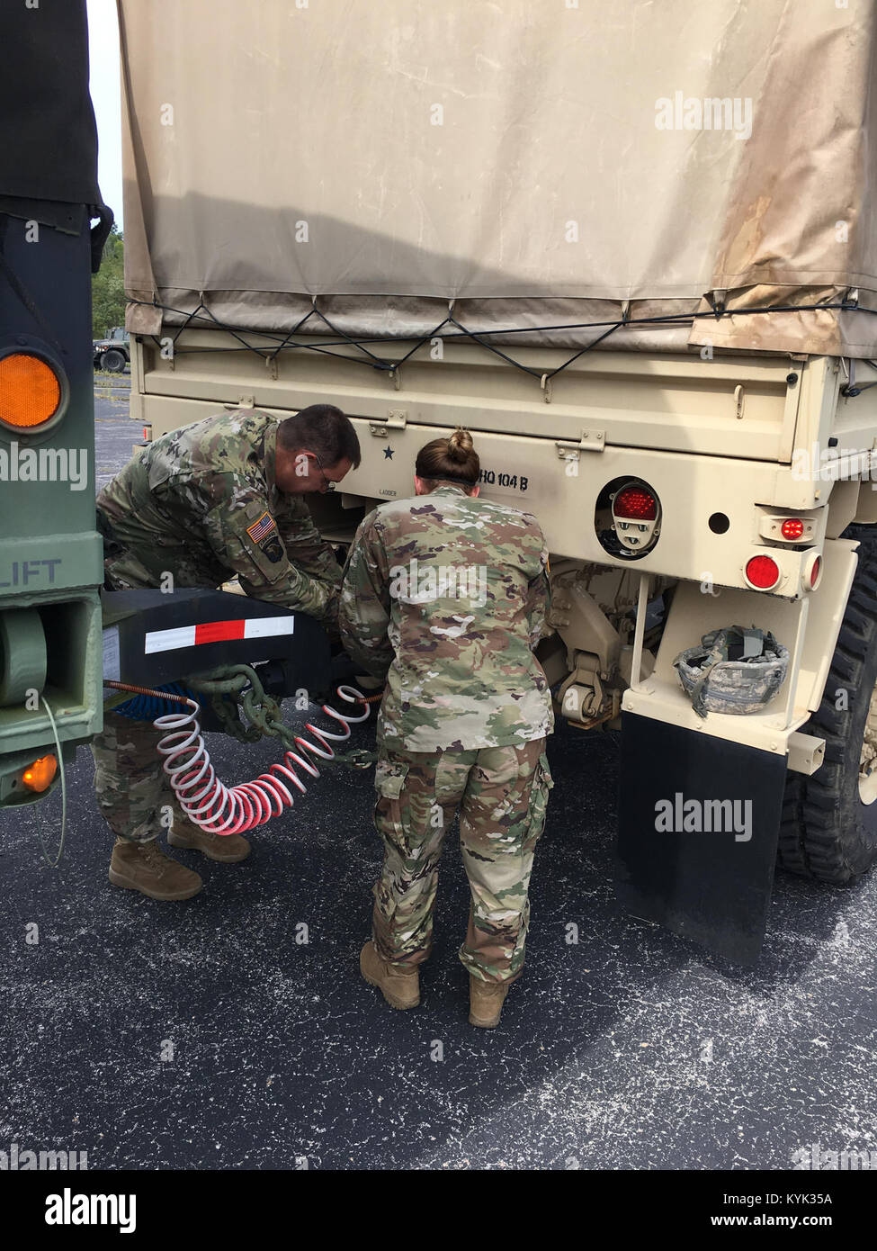 Soldiers with the 63rd Theater Aviation Brigade check connections on a ...