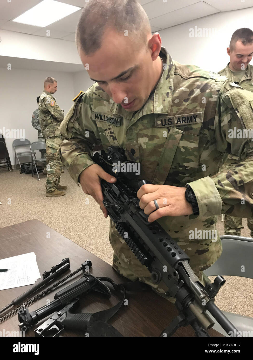 Spc. Justin Williamson, Kentucky National Guard, assembles an M249 ...