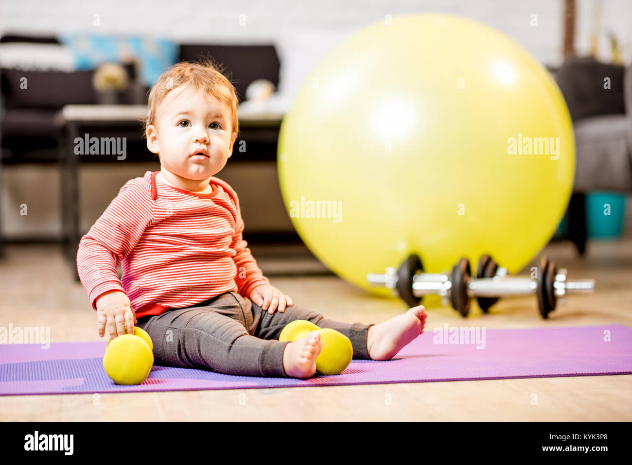 Baby boy portrait with dumbbells and fitness ball at home Stock Photo ...