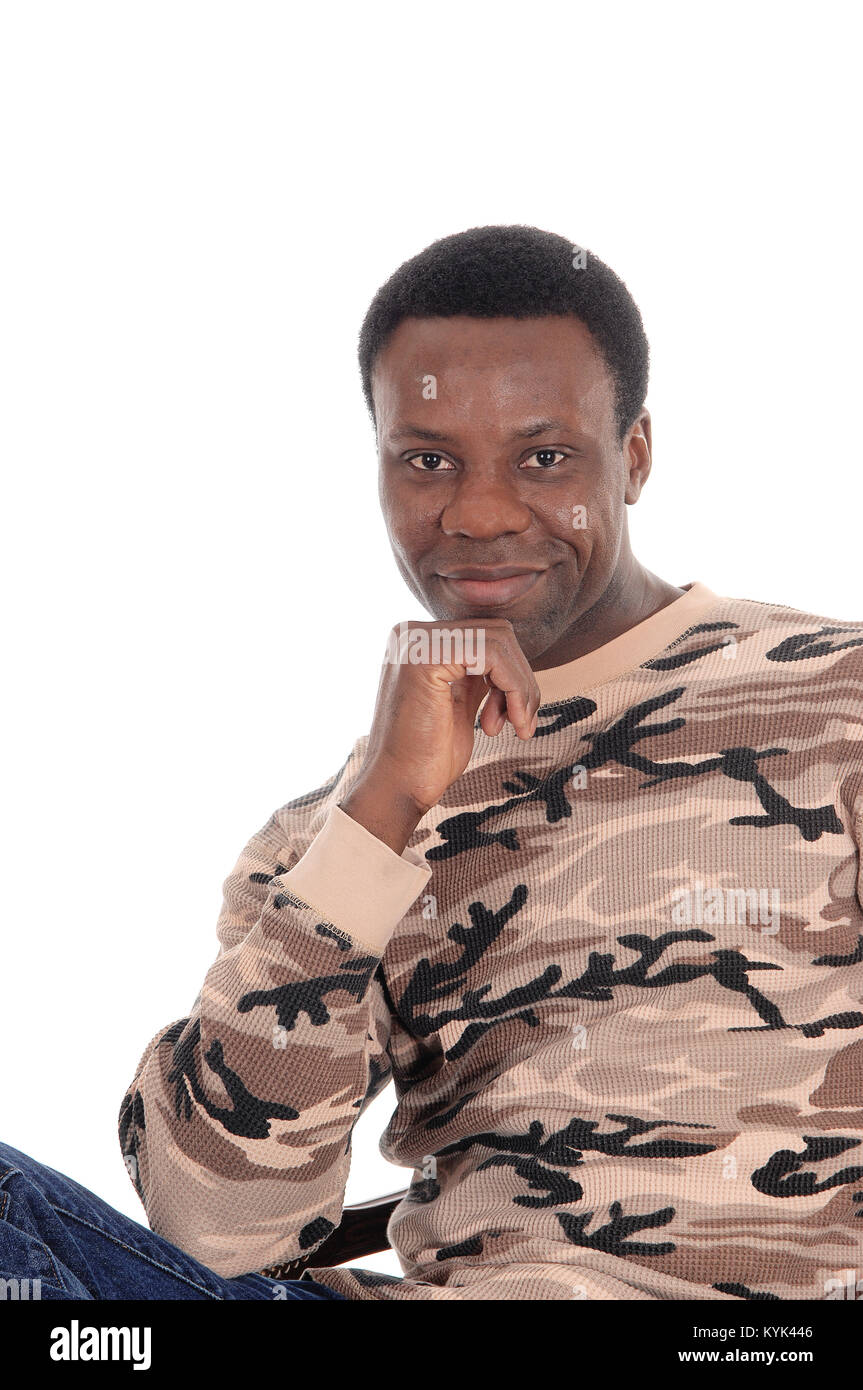 A happy and handsome African American man sitting with his hand on his ...