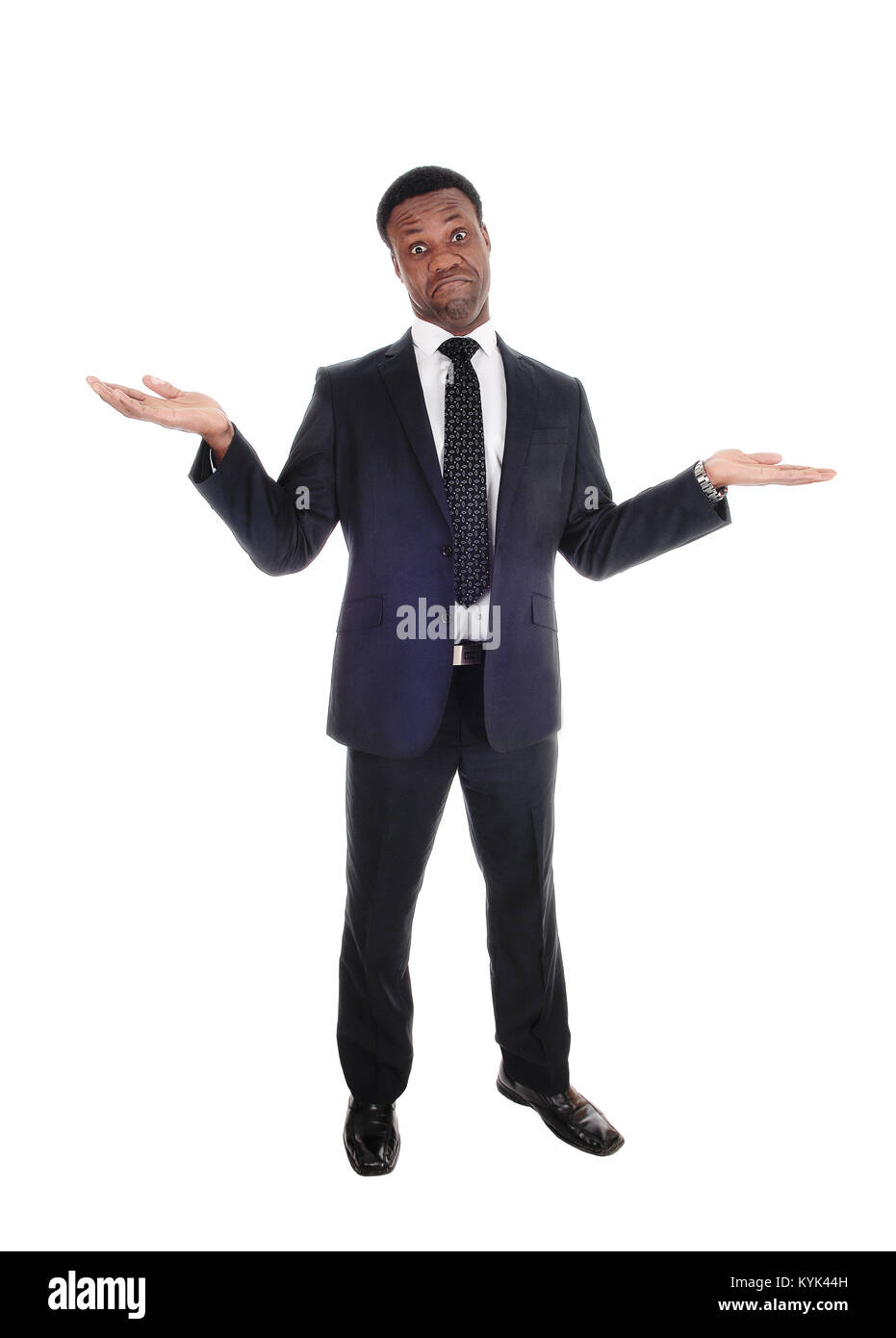 A handsome tall African American man standing in a suit with ...
