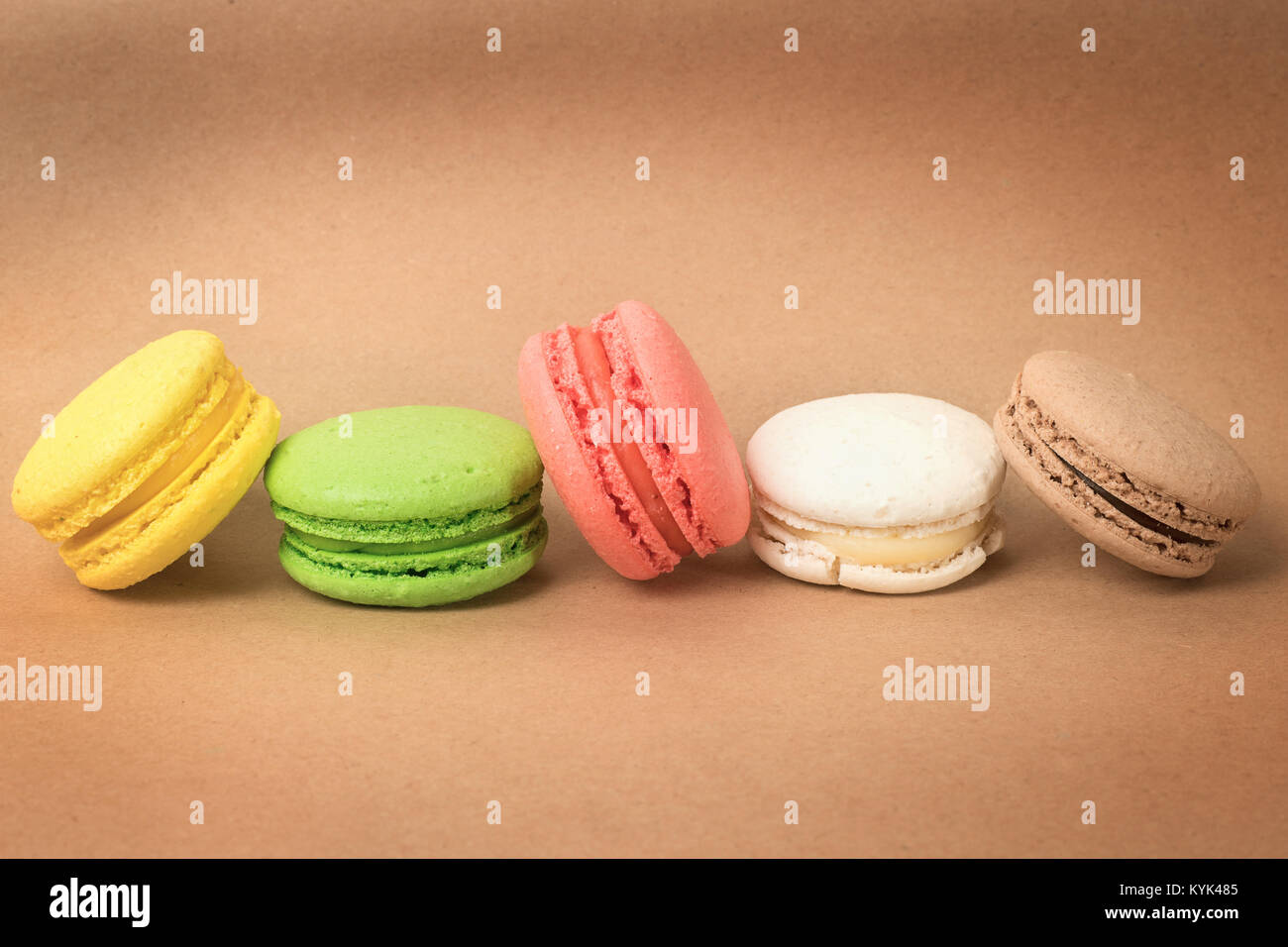 Colored macaroons on craft cardboard background. Soft toned image Stock ...