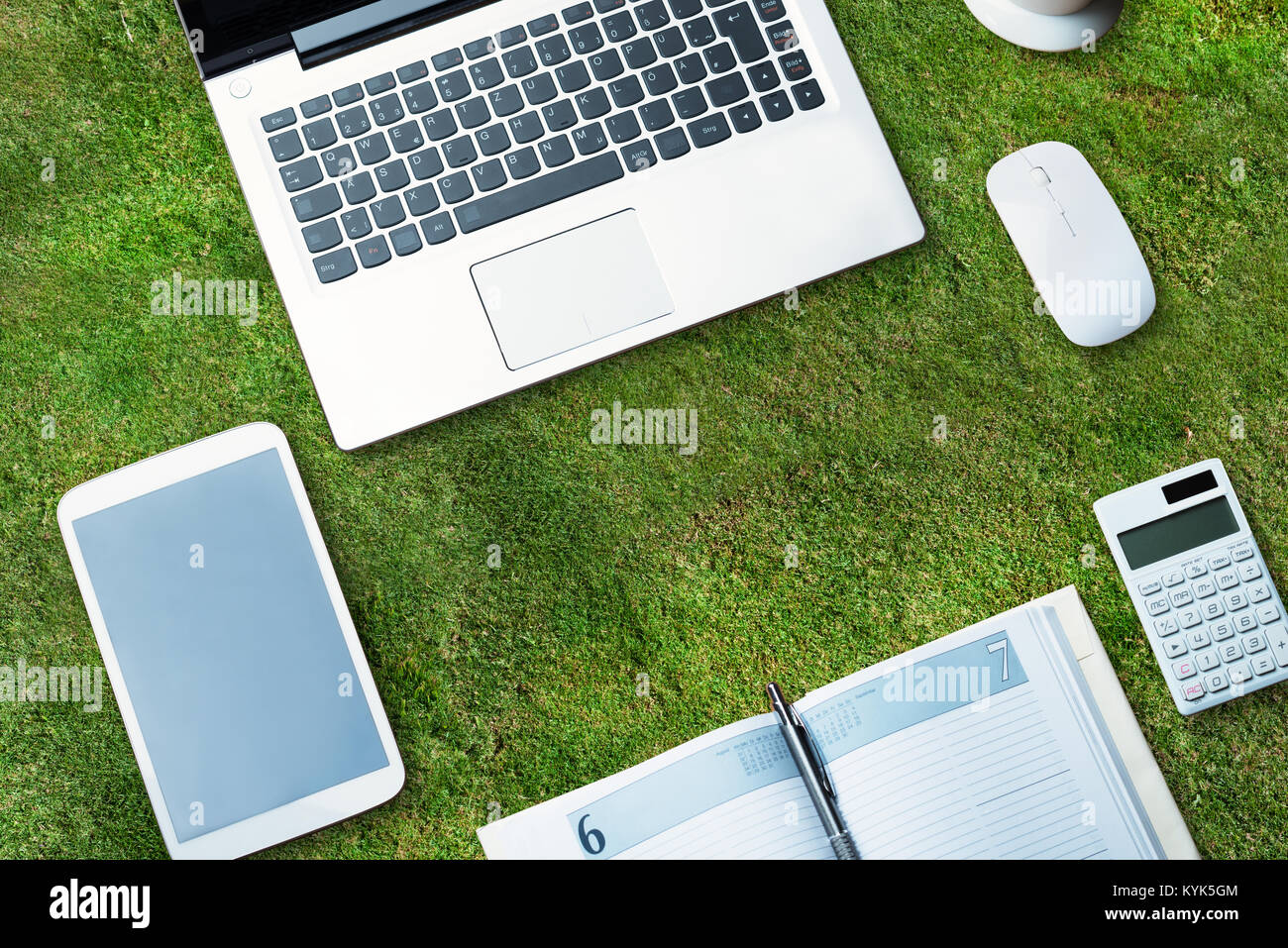 Elevated View Of Electronic Devices With Diary On Green Grass Stock ...