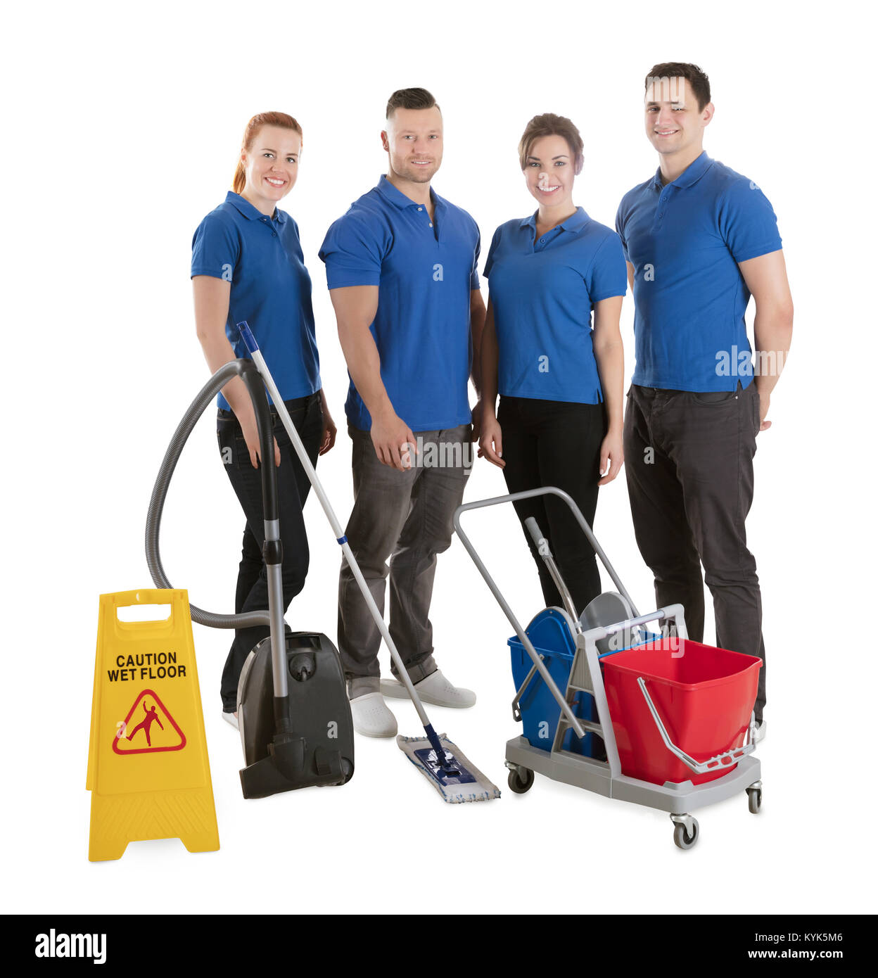 Portrait Of Happy Janitors With Cleaning Equipments Against White ...