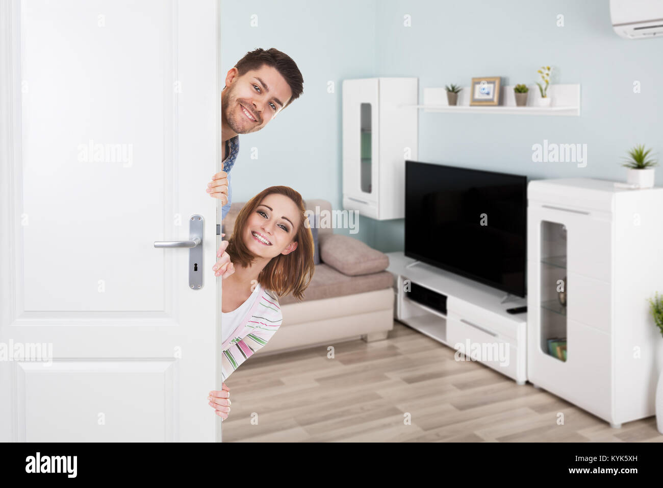 Man peeking door hi-res stock photography and images - Alamy