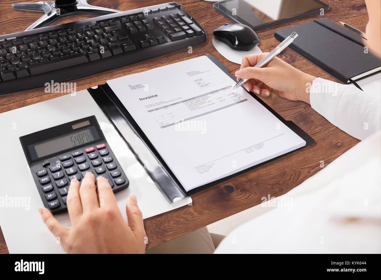 Close-up Of A Businessperson's Hand Calculating Invoice In Office Stock ...