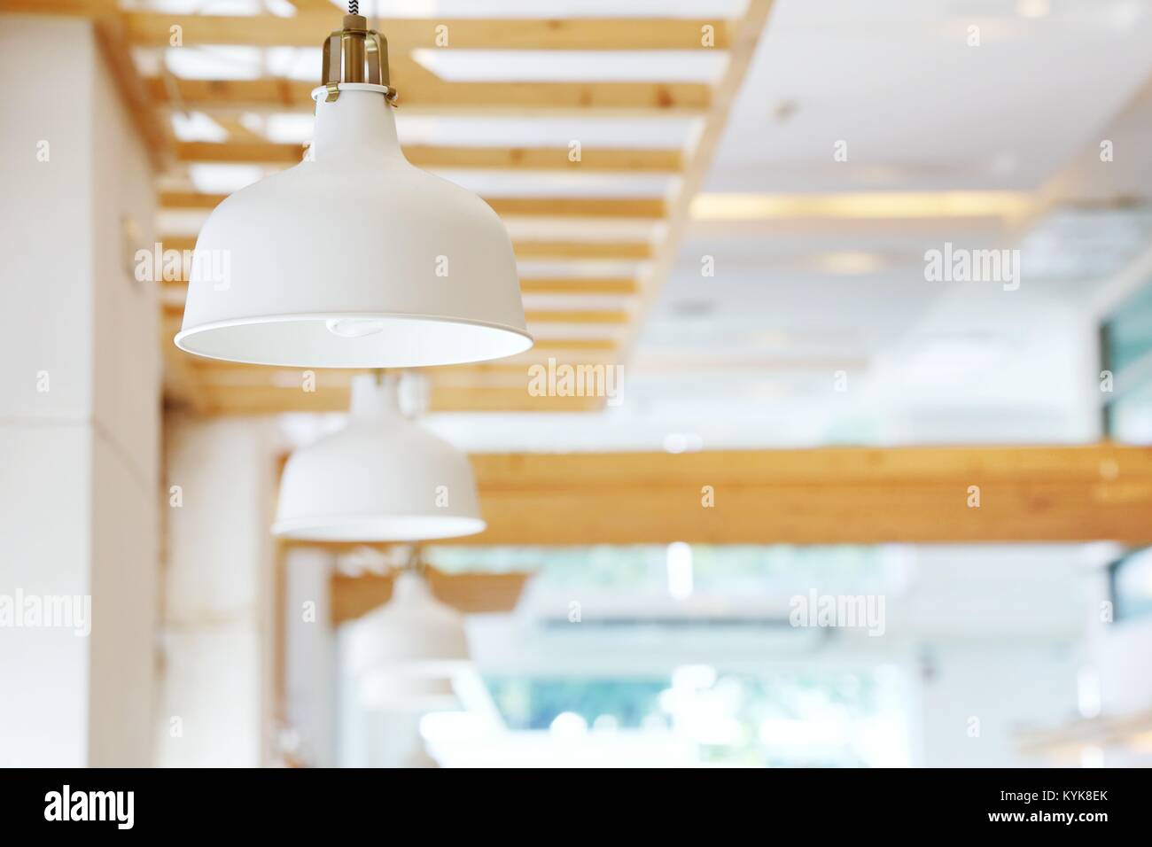 Close up of beautiful white simply modern ceiling lamps in restaurant ...