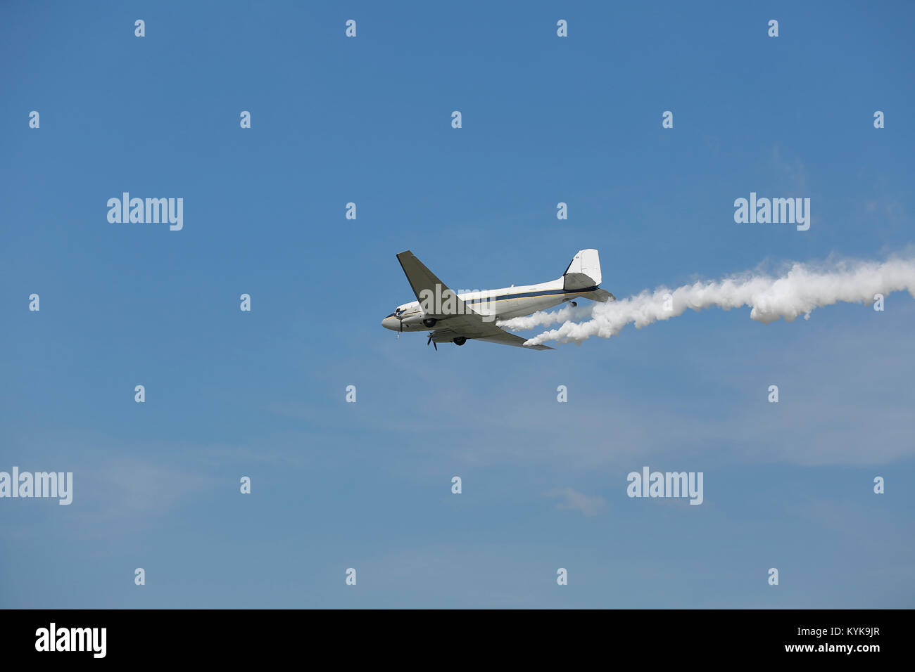 Airplane with smoke Stock Photo - Alamy
