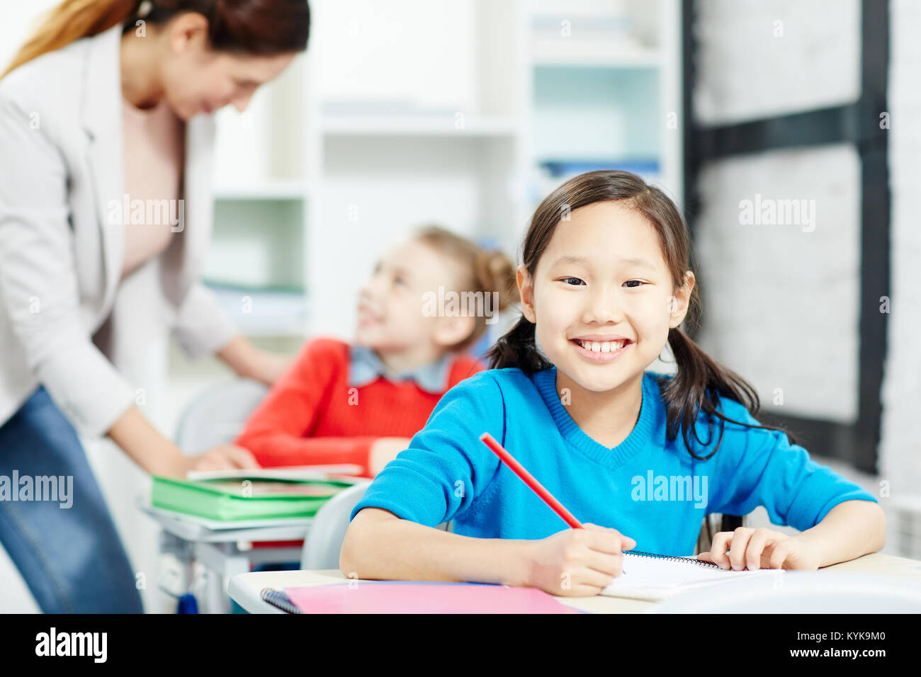 Happy schoolgirl looking classmate drawing hi-res stock photography and ...