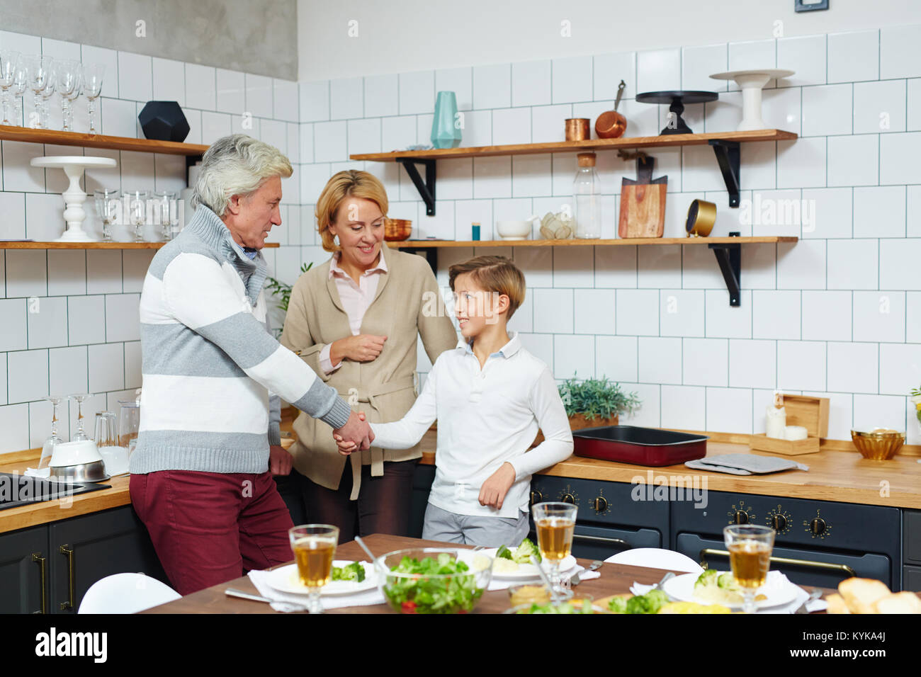 Handshaking in the kitchen Stock Photo - Alamy