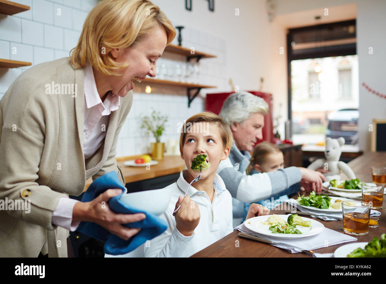 Boy eating broccoli Stock Photo - Alamy