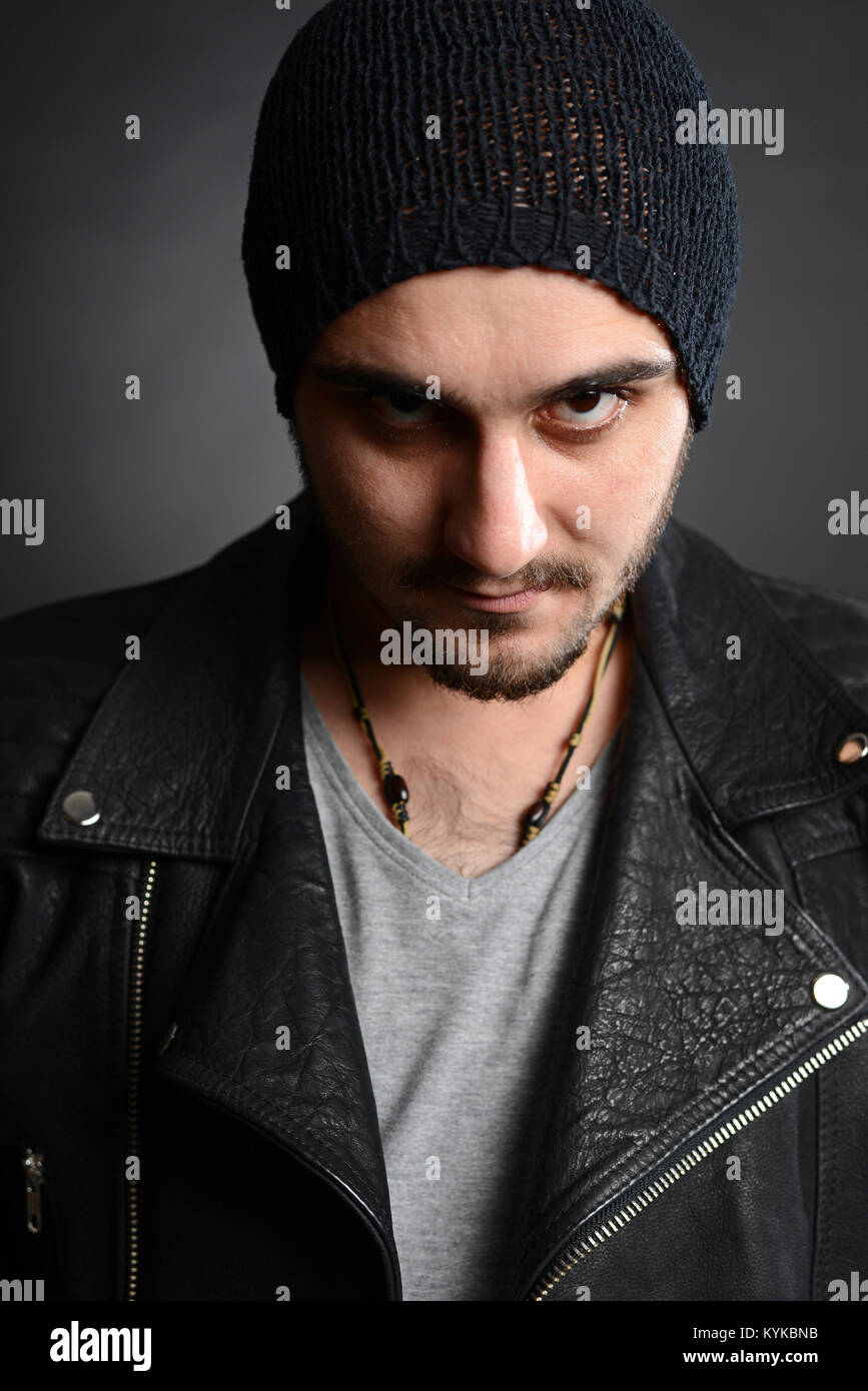 Rock singer portrait, with leather jacket and a cool attitude on black ...
