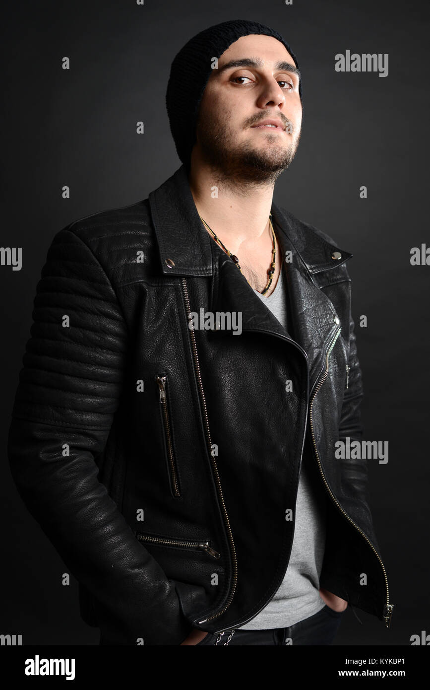 Rock singer portrait, with leather jacket and a cool attitude on black ...
