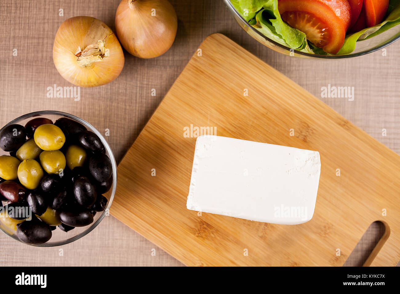 Top view on feta cheese next to glass bowl of olives Stock Photo - Alamy
