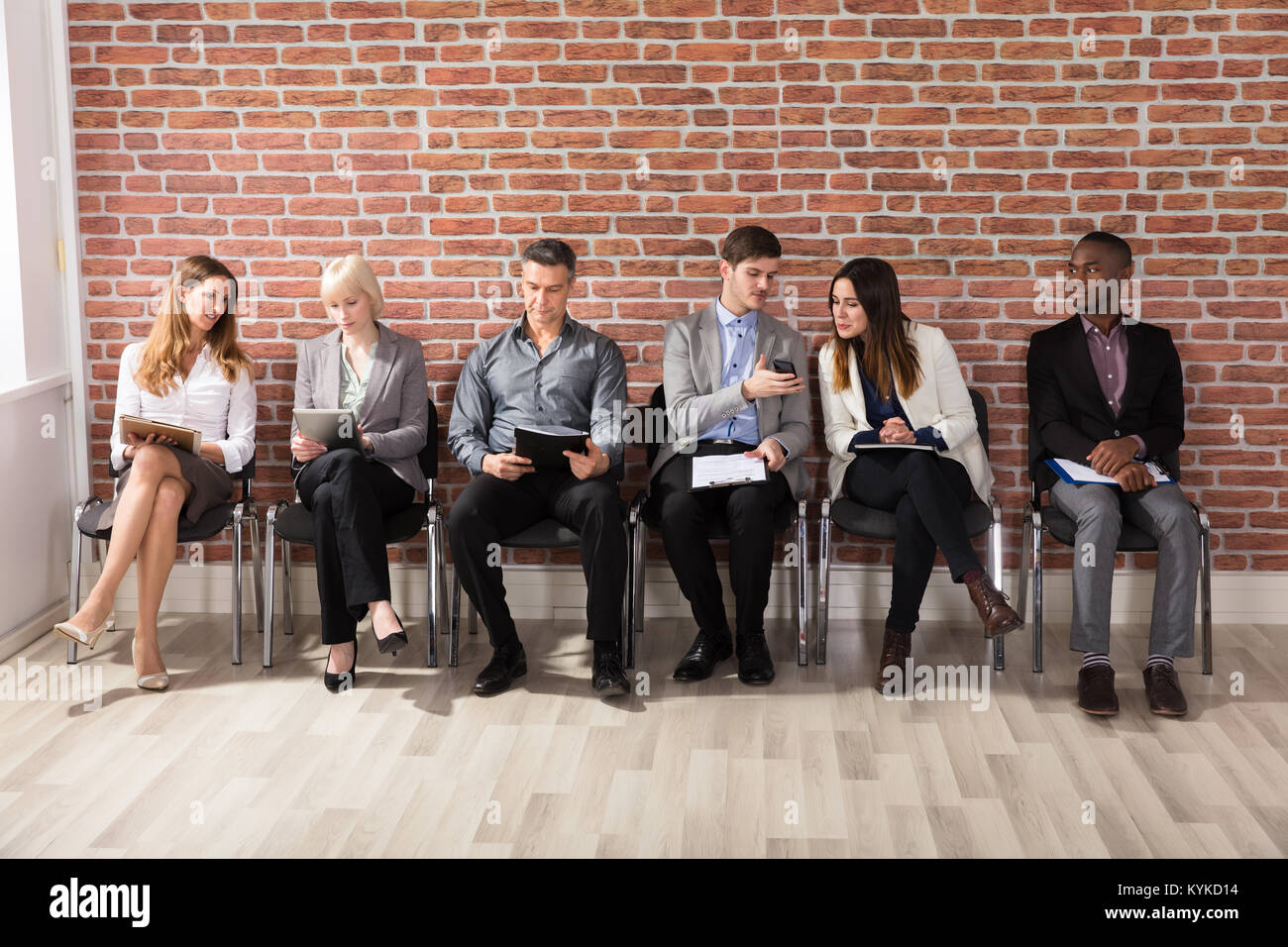 Group Of People Waiting For Job Interview In Office Stock Photo - Alamy