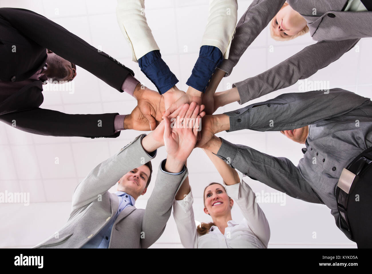 Group Of Businesspeople Putting Their Hands On Top Of Each Other ...