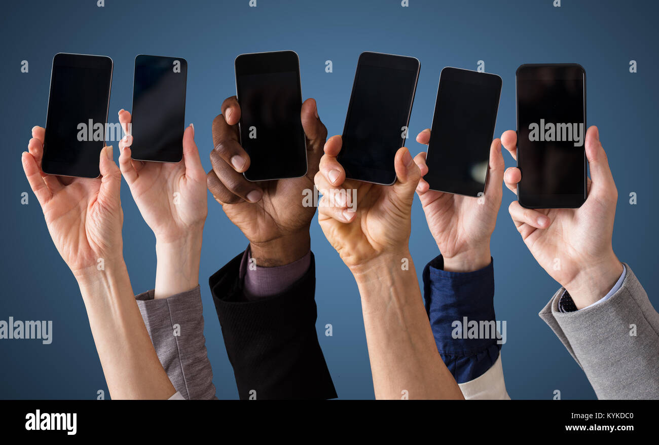 Human hands holding phones hi-res stock photography and images - Alamy