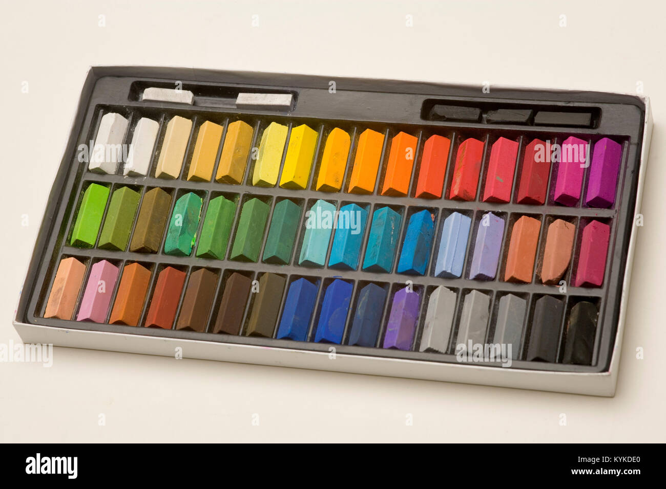 Multi coloured artists pastel crayons in a box Stock Photo - Alamy